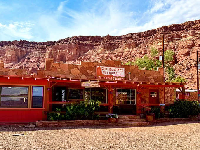 That bright red building against those towering cliffs looks like a movie set come to life.