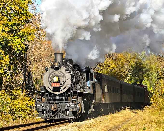 That billowing steam against autumn gold is pure magic&mdash;like watching a Norman Rockwell painting come alive.