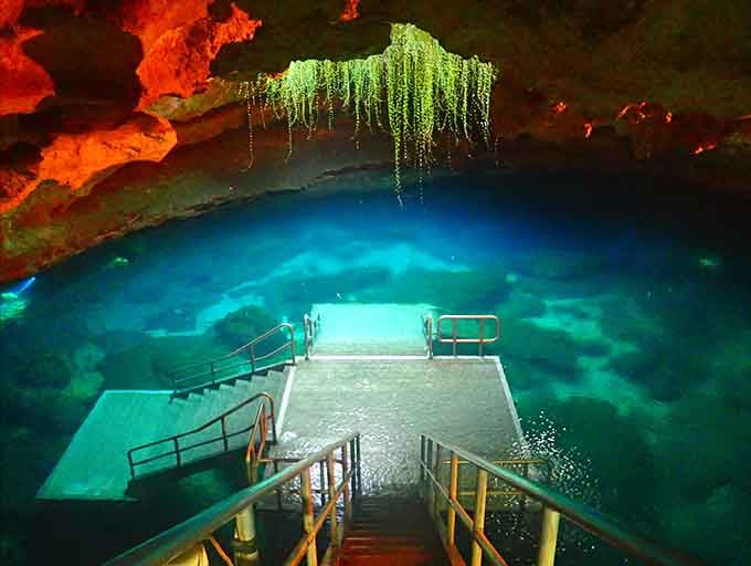 That electric blue glow makes this underground cave look like something from a sci-fi movie set.