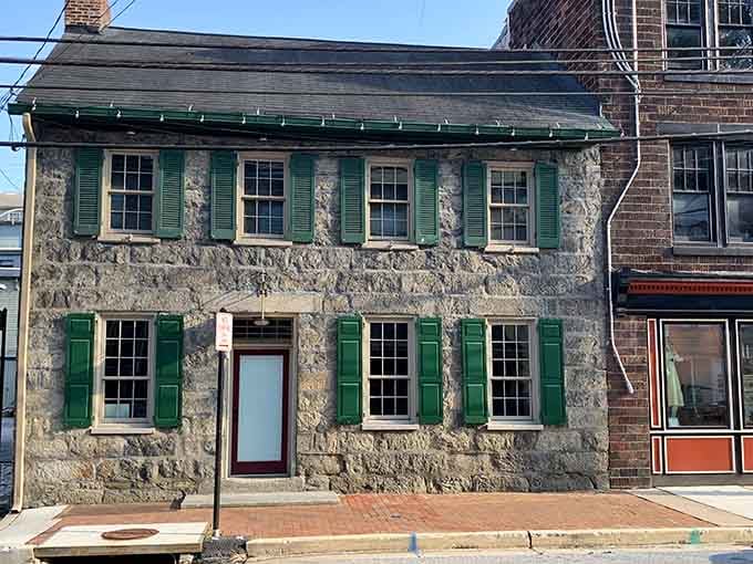 Stone walls and green shutters tell stories older than your favorite black-and-white movies ever could.