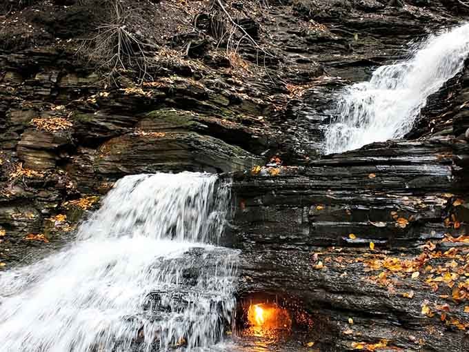 Fire and water together? Nature's playing tricks at this magical waterfall where a golden flame flickers eternally.