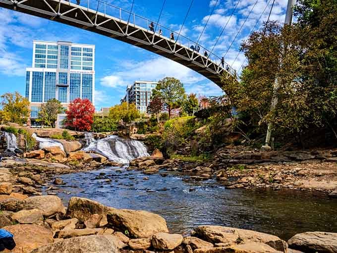 Nature meets downtown in this stunning waterfall oasis where city buildings frame cascading water and autumn colors.