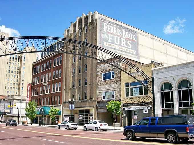 Historic brick buildings stand proud under blue skies, reminding us that affordable living has architectural charm too.