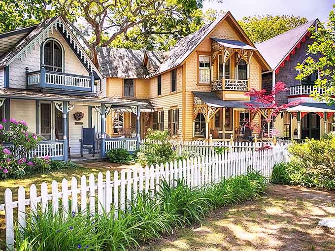 These pastel cottages look like Hansel and Gretel's neighborhood got a cheerful makeover with white picket fences everywhere.
