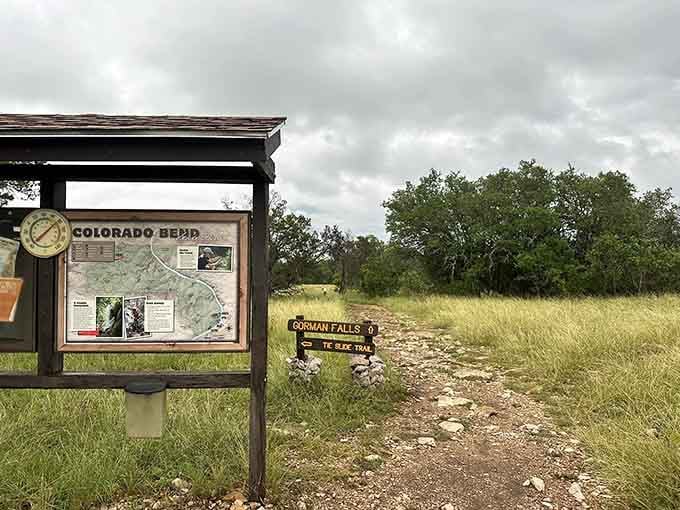 That trailhead sign pointing toward Gorman Falls is your invitation to discover one of Texas's best-kept waterfall secrets.