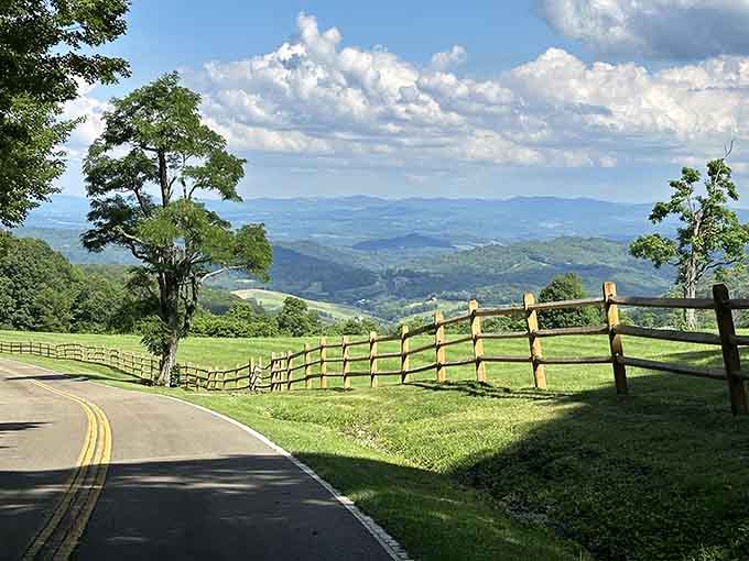 This winding mountain road frames layers of blue ridges like nature's own screensaver come to life.