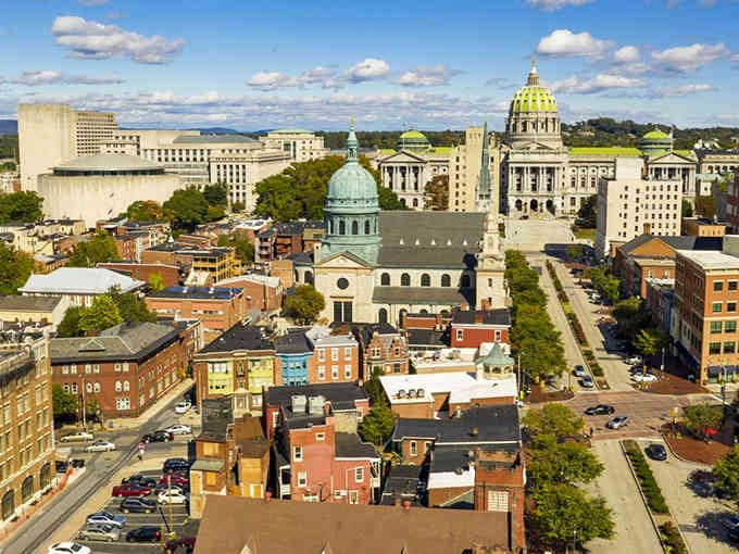 That green dome rising above colorful rooftops proves state capitals can be surprisingly charming and walkable.