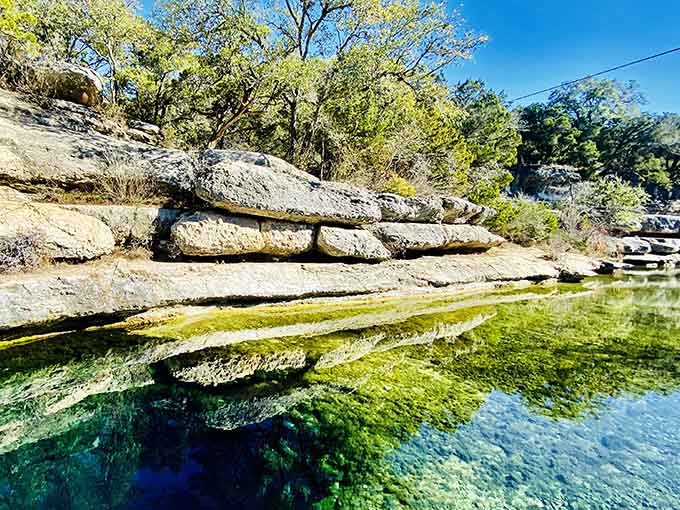 That emerald water is so clear, you can see straight down into nature's own infinity pool carved in limestone.