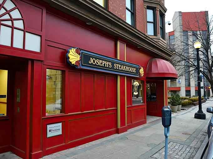 That bold red facade practically shouts "come eat steak!" and honestly, who could resist such a colorful invitation?