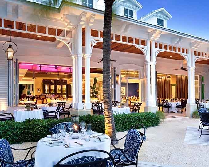 Those white columns and pink sunset glow make this waterfront paradise look like a movie set come to life.