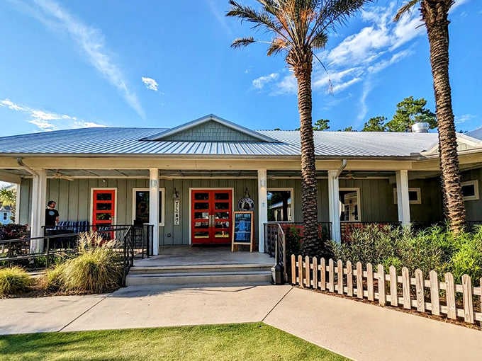 Those palm trees and bright red doors are basically waving you inside for coastal comfort food and legendary pie.