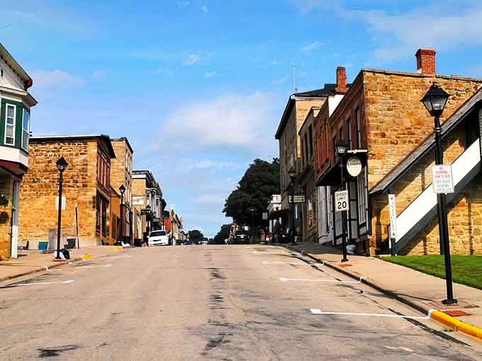 Golden limestone buildings glow under blue skies, creating a streetscape that looks like a Western movie set.