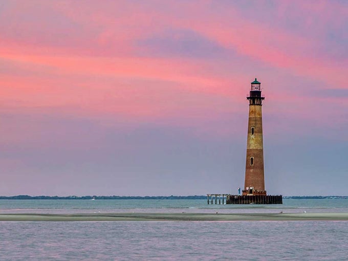 Cotton candy skies meet weathered brick as this solitary sentinel stands guard in tranquil evening waters.