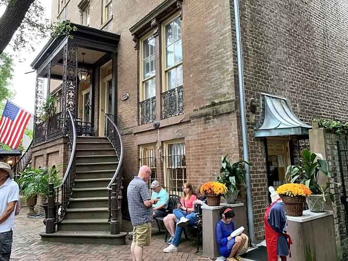 That wrought-iron staircase and historic brick facade whisper stories of countless family-style feasts shared inside.