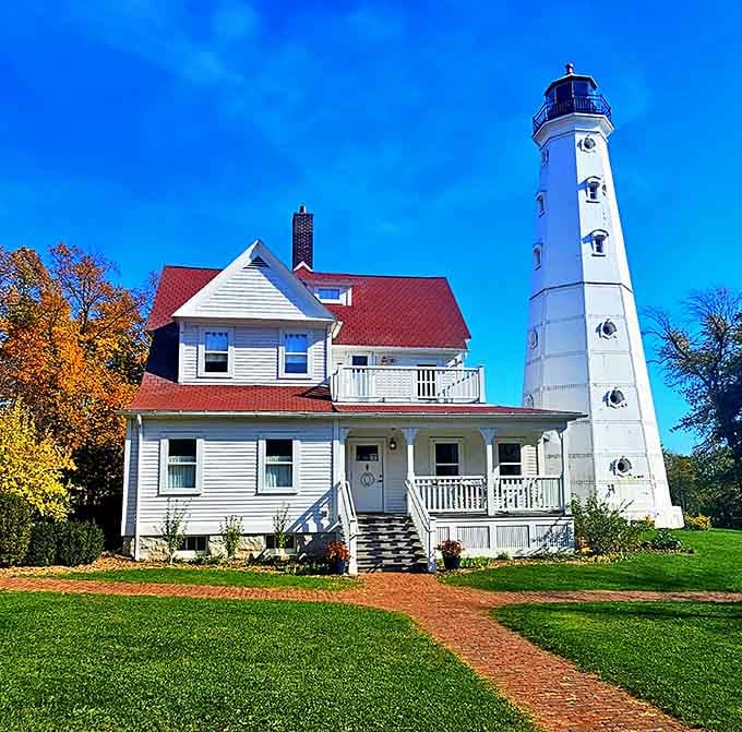 That red roof against autumn leaves makes this keeper's house look like a Norman Rockwell painting come to life.