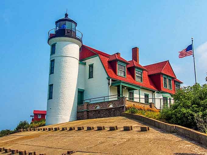That red roof against the white tower is pure Michigan magic, standing proud like a postcard from simpler times.