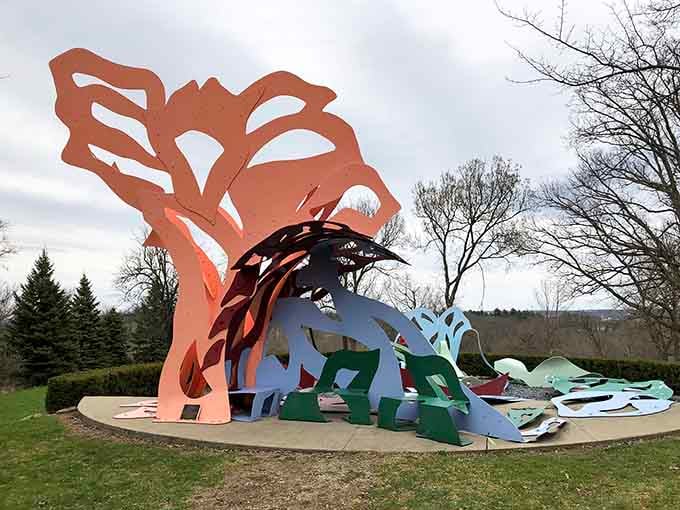 Like a giant's art box exploded in the countryside, these vibrant sculptures dance across rolling green hills.