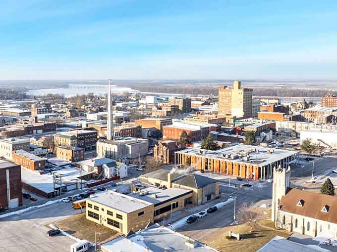 Winter sunlight bathes this riverside city where historic brick buildings stand proud against endless Midwest skies.