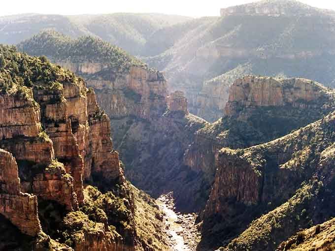 Mother Nature carved this masterpiece with patience and precision, layering rust-colored cliffs like a geological wedding cake.