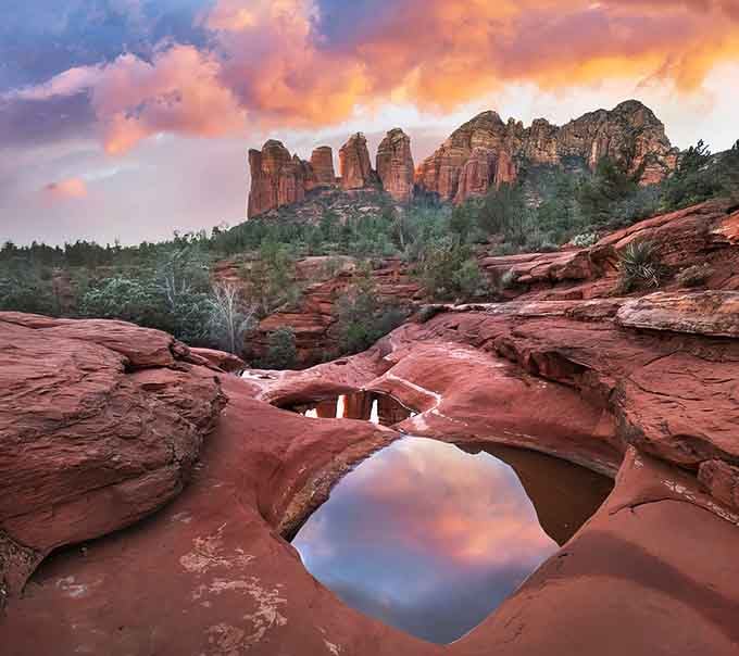 Nature carved these red rock pools like bowls, then filled them with sky reflections that'll make your camera very happy.