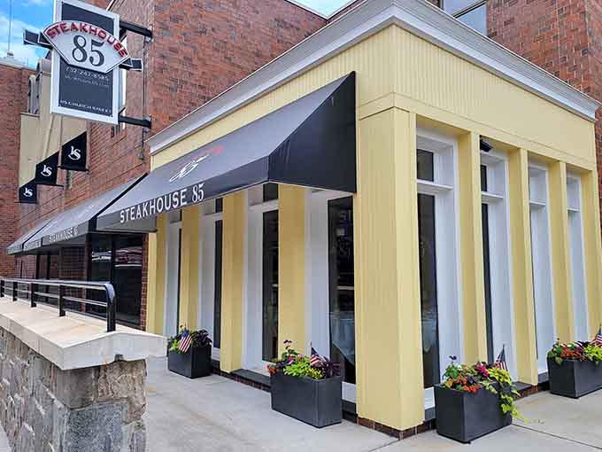 Those cheerful yellow and white stripes hide some seriously impressive steaks behind that sleek black awning.