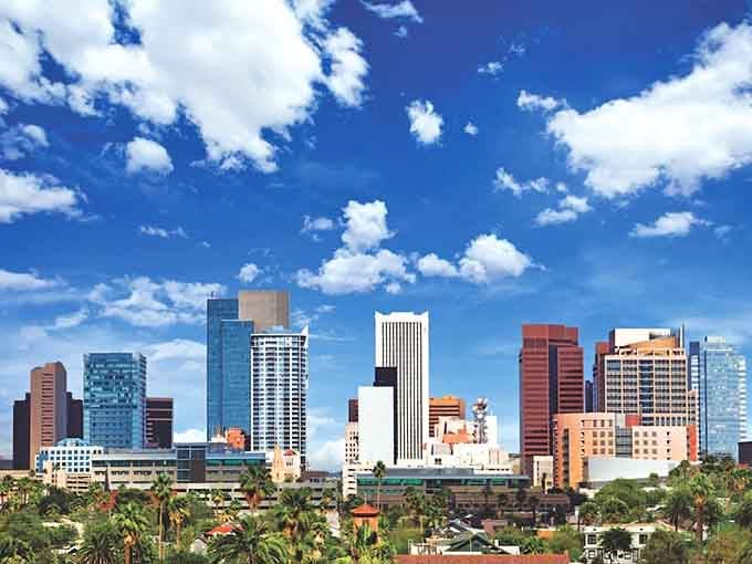 Modern towers rise against cotton-candy clouds while palm trees whisper that retirement here means endless blue skies.