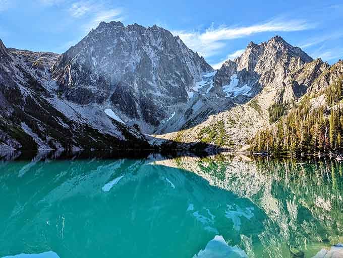 That turquoise water against granite peaks creates a mirror so perfect you'll question which way is up.