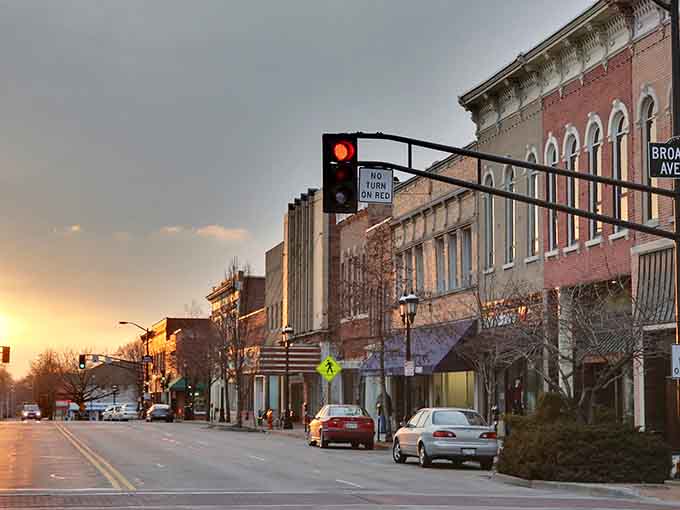 Golden hour paints this downtown street in warm light, where historic brick buildings whisper stories of simpler times.