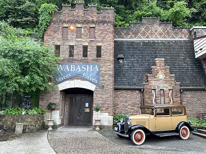 That vintage yellow coupe parked outside these historic caves sets the perfect gangster-era mood for adventure.