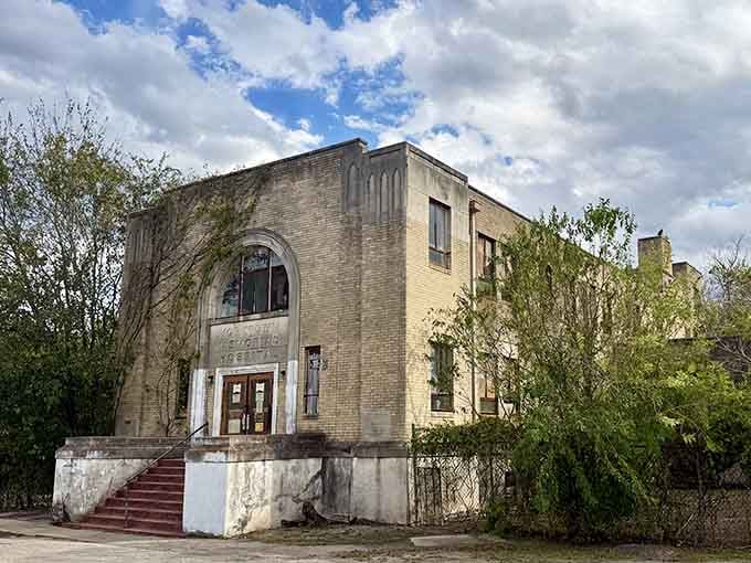Nature's reclaiming this abandoned hospital brick by brick, creating a scene straight from a Stephen King novel.