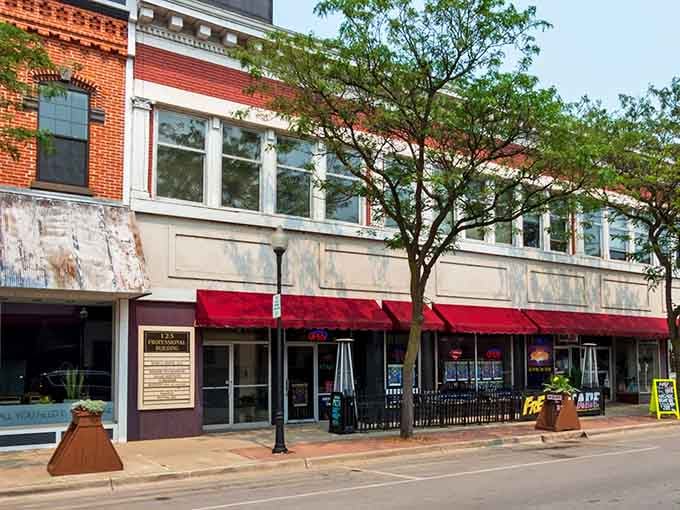 Those red awnings beckon like a welcome mat, inviting you to discover downtown charm that's refreshingly affordable.