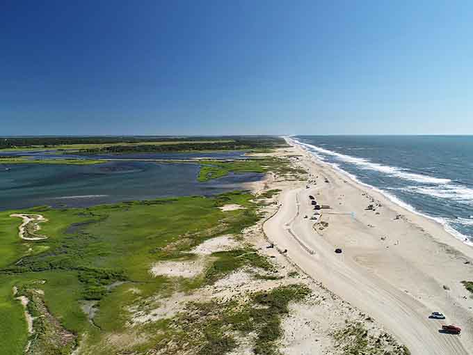 This barrier island stretches endlessly where ocean meets bay, creating two worlds in one magical place.