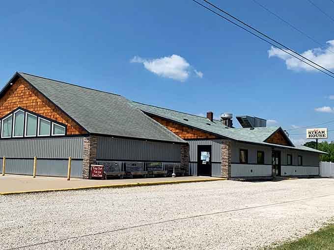 The wood-accented facade and gravel parking lot signal honest, no-frills dining where the steak does all the talking.
