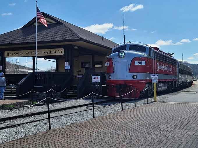 That red and silver locomotive gleams under blue skies, ready to whisk passengers through the beautiful Branson countryside.
