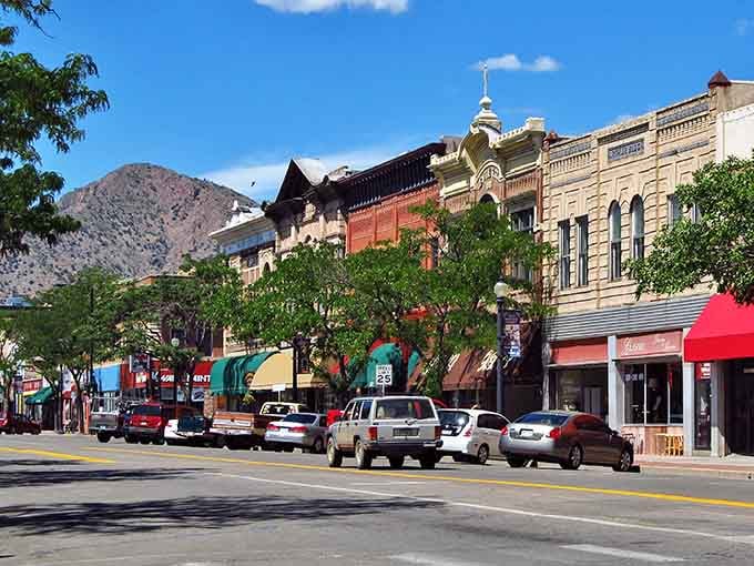 Historic storefronts line sunny sidewalks where neighbors still greet each other by name, not just screen names.
