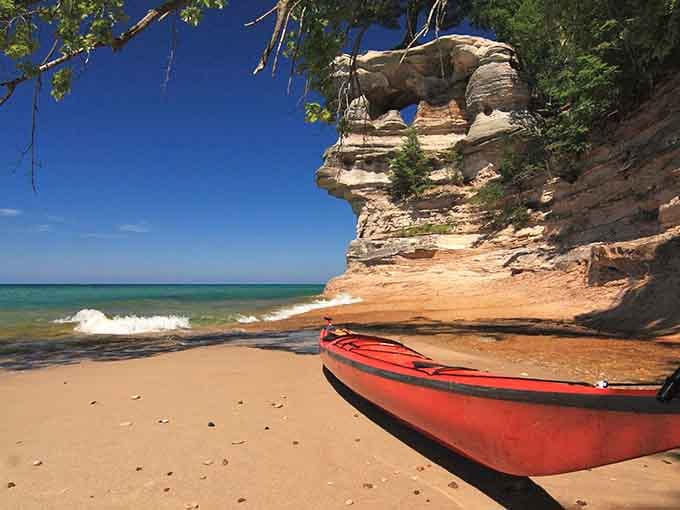 That red kayak knows what's up—sometimes the best seat in the house is right on the sand.