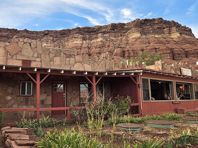 The stone walls blend right into the natural rock formations, creating a dining room carved by nature itself.