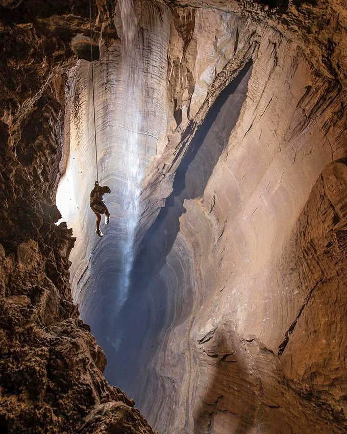That tiny figure rappelling down shows just how massive this underground chamber really is&mdash;absolutely breathtaking scale.