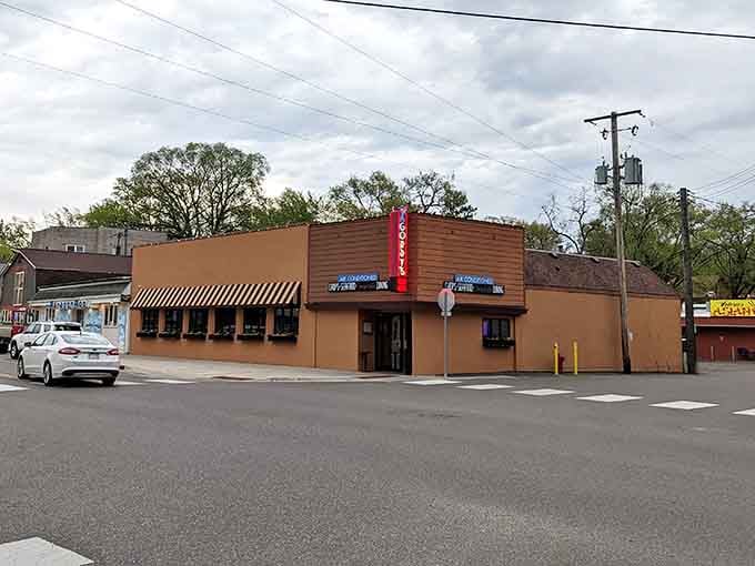 The red vertical sign beckons like a lighthouse guiding hungry travelers to perfectly seared beef heaven.