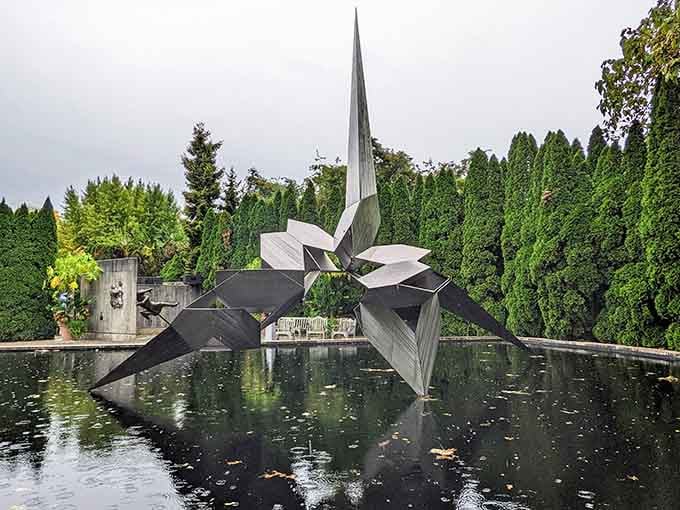 This striking modern sculpture emerges from reflecting pools, proving that contemporary art and nature make surprisingly harmonious neighbors.