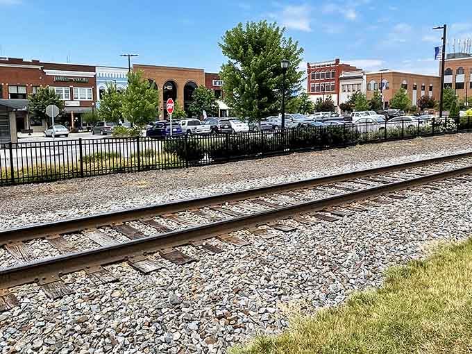 Railroad tracks frame this inviting downtown where storefronts beckon and that big tree provides perfect shade for afternoon strolls.