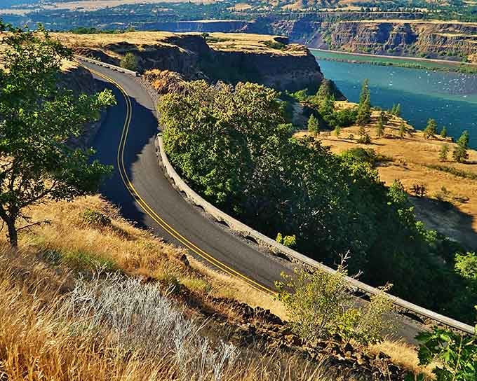 The Columbia River curves below like a silver ribbon while the highway dances along clifftops above.