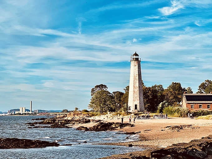 That tall white tower against the brilliant blue sky is pure New England magic at its finest.