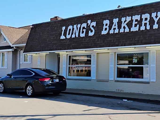 Those cheerful window displays promise fresh-baked happiness waiting inside, like a sweet beacon calling you home for breakfast.