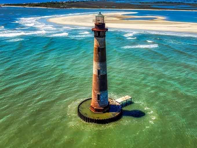 From above, those Caribbean-blue shallows and swirling sandbars create nature's own watercolor masterpiece around this historic tower.
