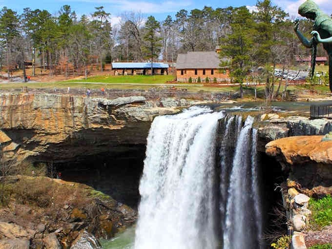 That dramatic 90-foot drop creates a thundering spectacle framed by ancient rock formations and lush greenery.
