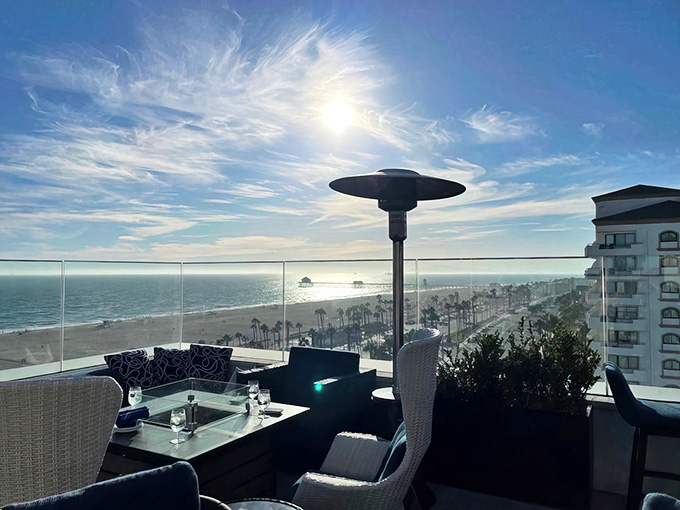 Golden hour transforms this coastal perch into pure magic with palm trees swaying below.