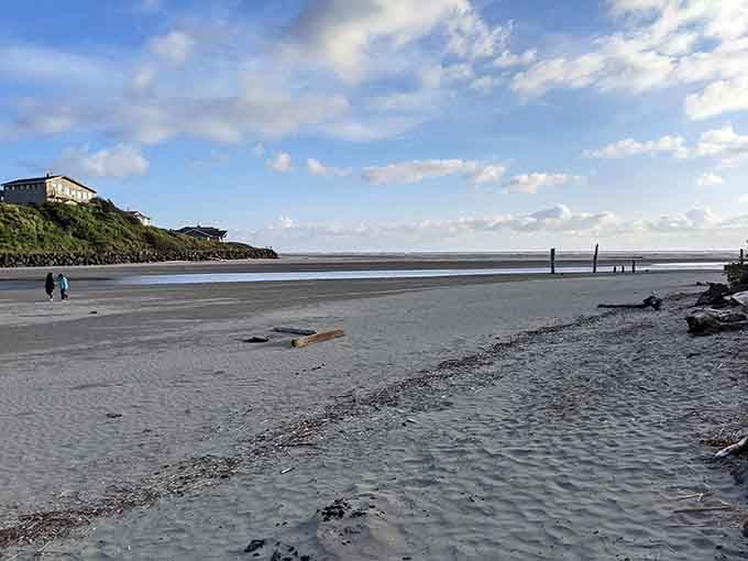 Low tide reveals nature's artistry in rippled sand patterns, with beachcombers discovering treasures along the peaceful shoreline.