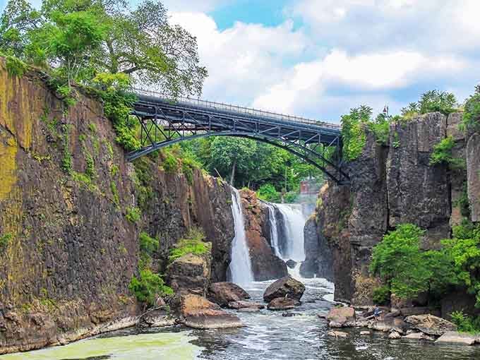 That historic iron bridge frames the thundering falls like a postcard from America's industrial revolution come to life.