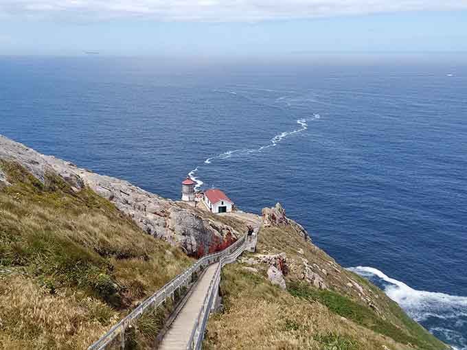 Perched on dramatic cliffs where the Pacific meets rugged rocks, this beacon stands guard over endless blue horizons.
